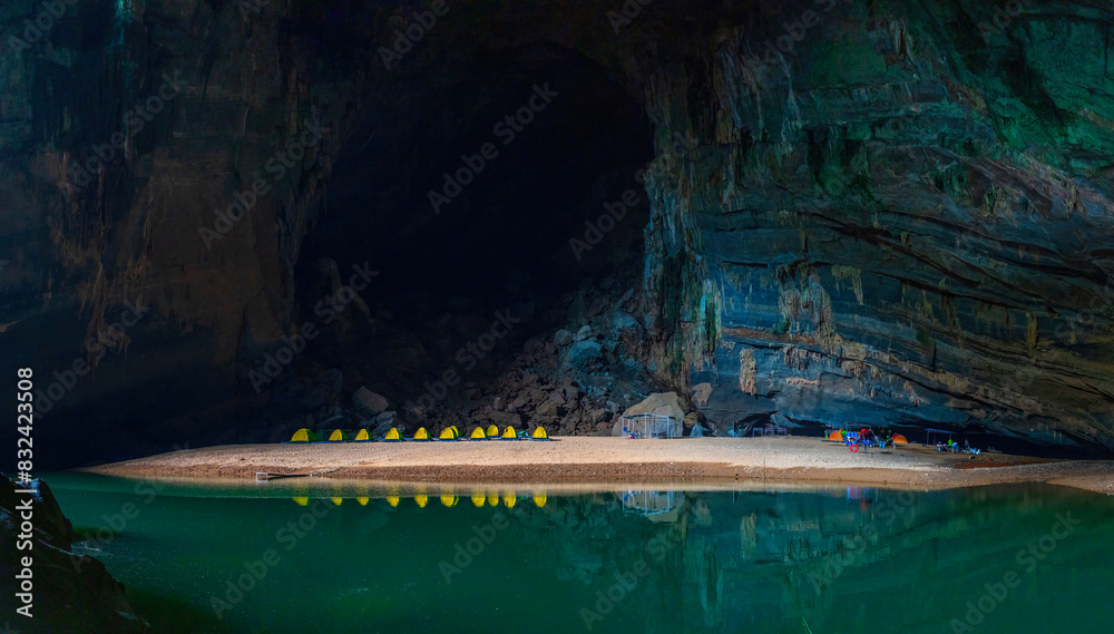 View of the camp site across the lake in Hang En Cave, the first cave ...
