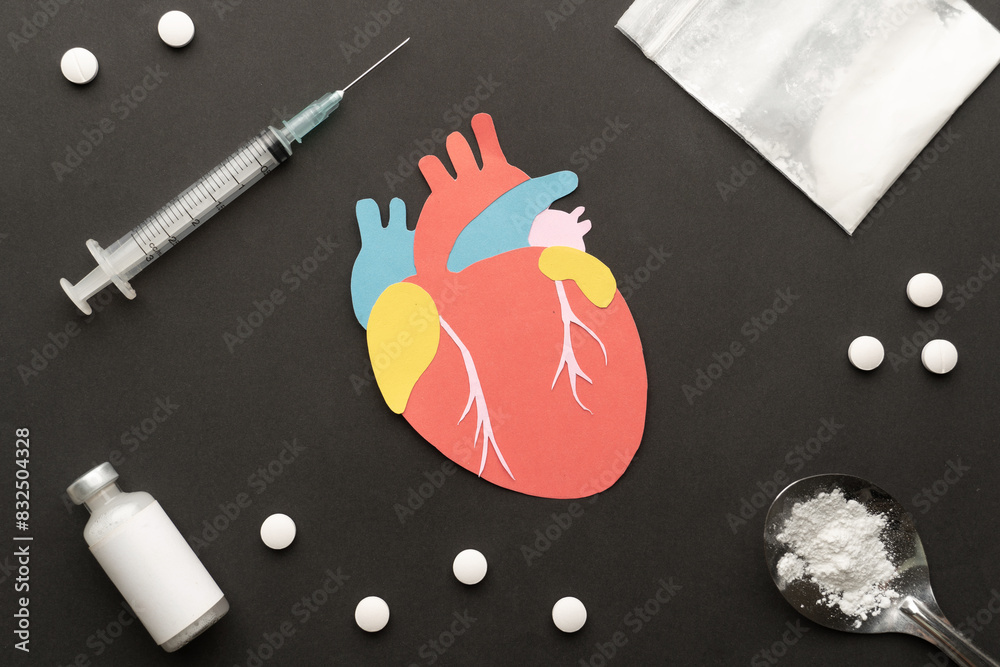 Effects of drugs on the human heart. Paper cut of heart with drug ...