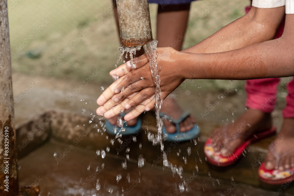 Children washing their hands at an outdoor water tap. Keep your hands ...
