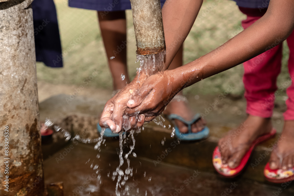 Children washing their hands at an outdoor water tap. Keep your hands ...