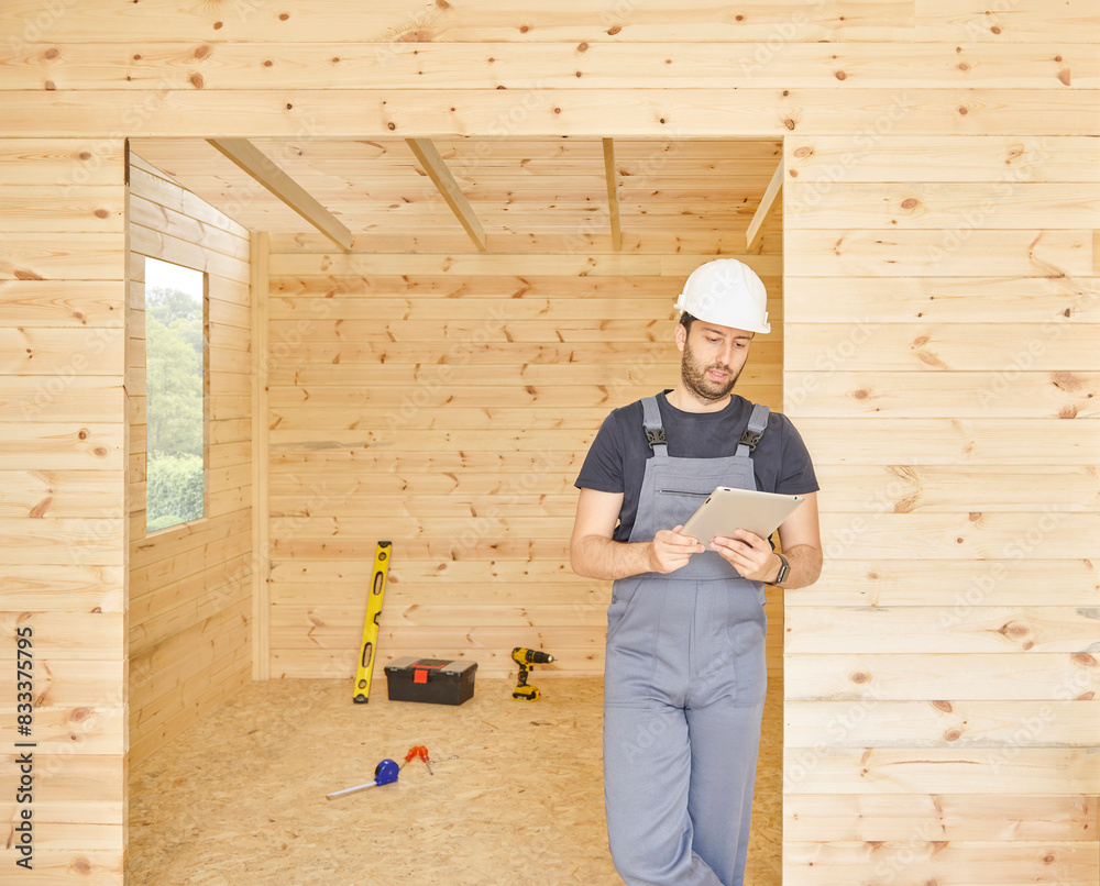 Construction man, builder man construct new wooden home, tiny house ...