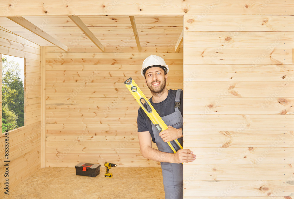 Construction man, builder man construct new wooden home, tiny house ...