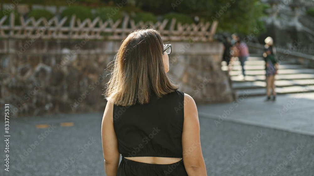 Beautiful hispÃ¡nic woman, glasses perched atop, captured in a casual ...