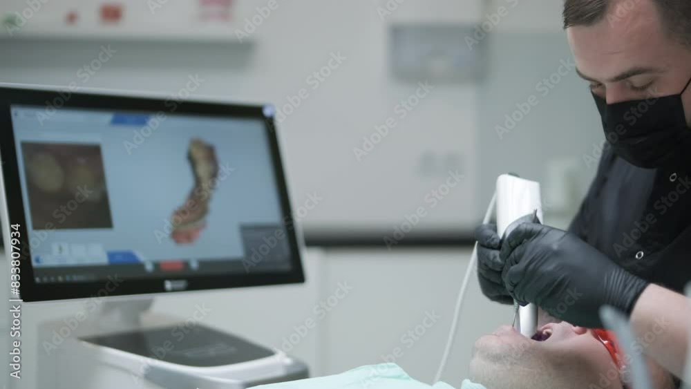Doctor scans the patient's teeth in the clinic. The dentist holds in ...