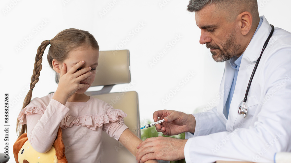 Little kid girl terrified by injection at hospital, being afraid of ...