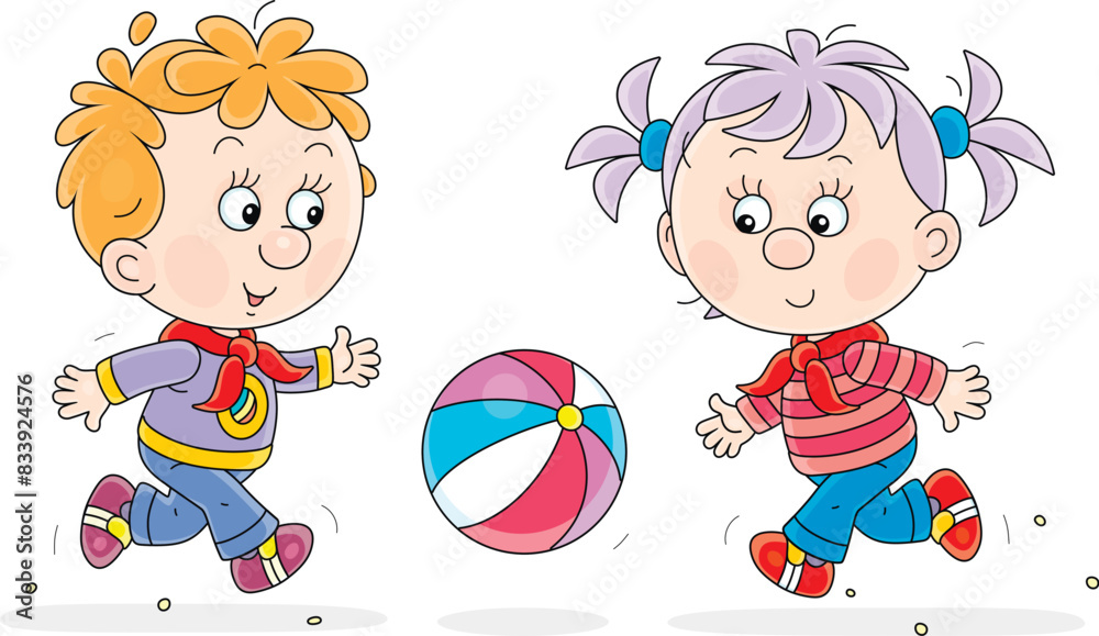 Funny little girl and boy merrily running and playing with a colorful ...