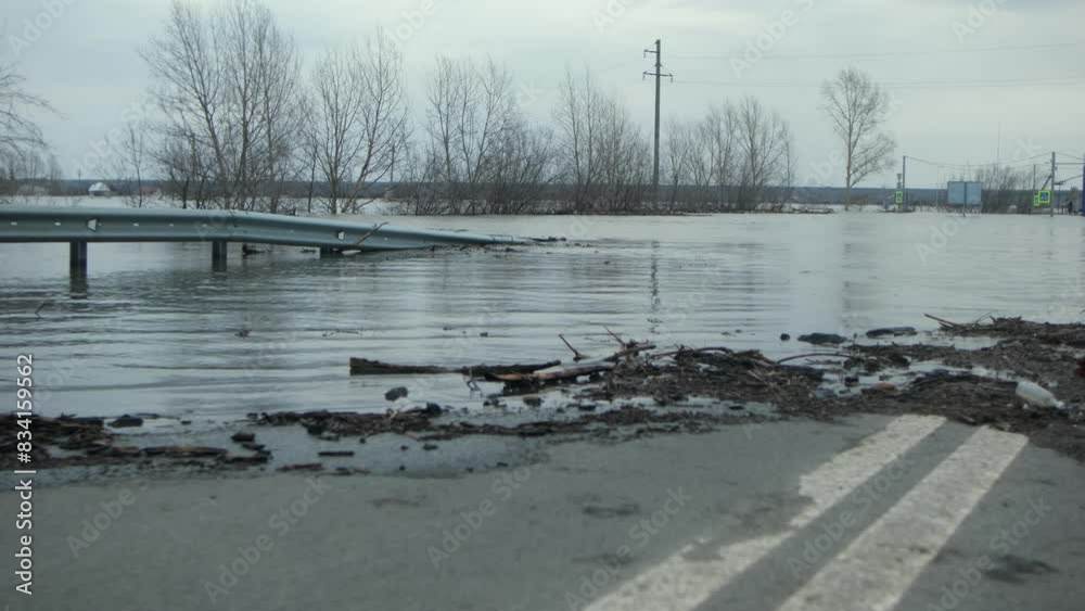 Asphalt road is submerged under muddy flood water and impassable for ...