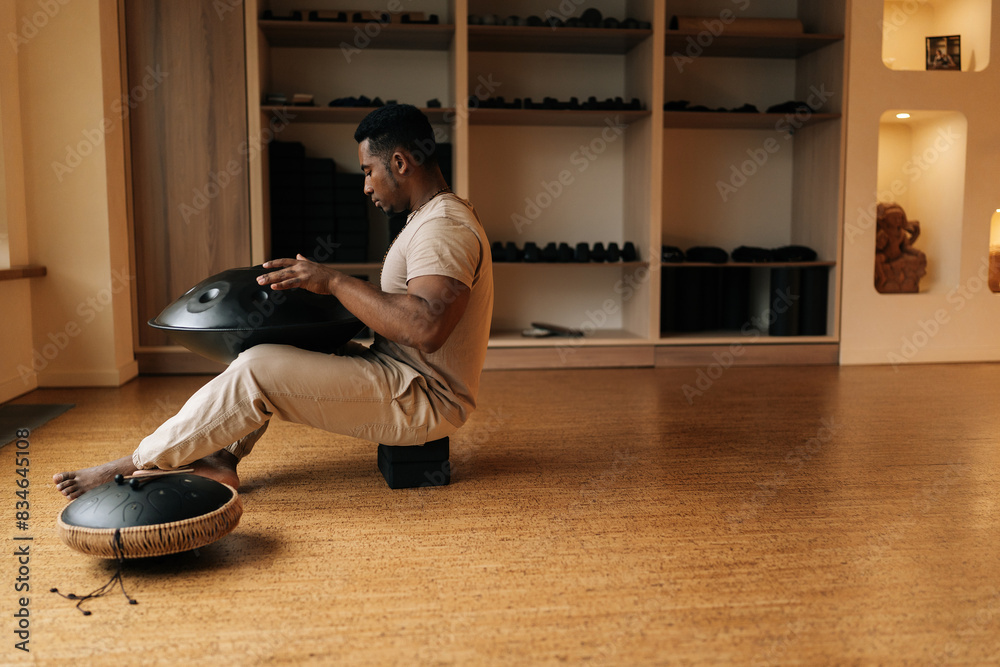 Side view portrait of African man in trance enjoying playing by hands ...