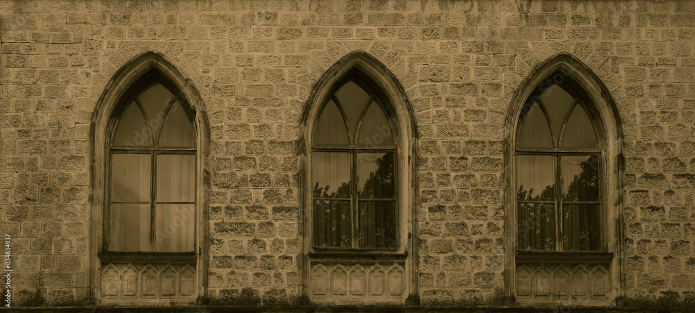Beautiful details of old windows on rock wall. Facade of a medieval ...