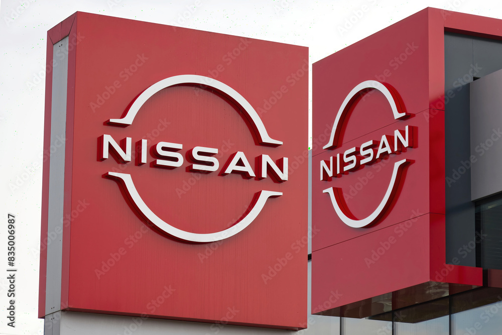Nissan logos on car selling and service center. Nissan is a Japanese ...