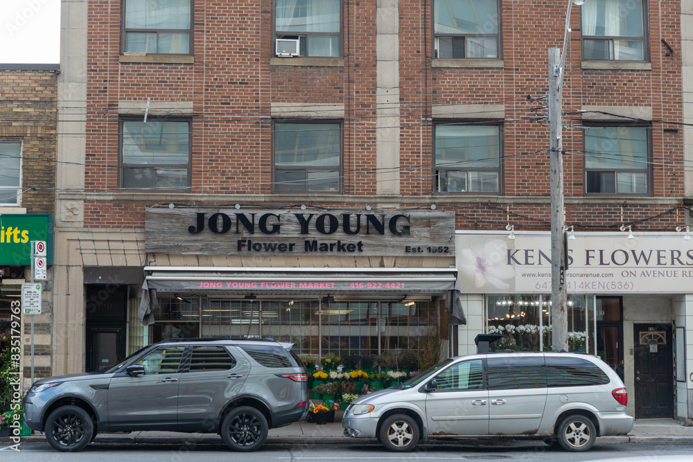 exterior building facade and sign of Jong Young Flower Market, a florist, located at 128 Avenue ...