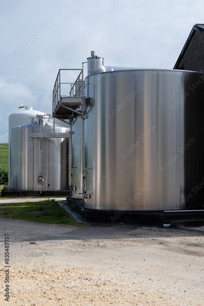 Works at distillery in Cognac white wine region, Charente, steel tanks ...