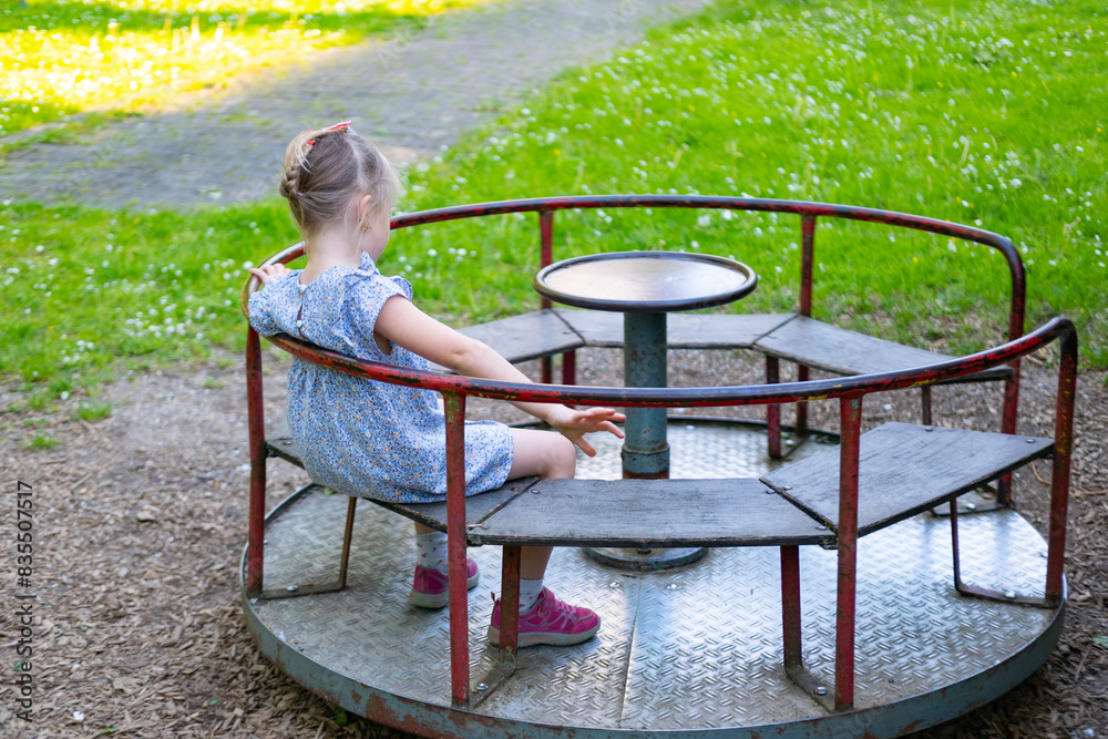 happy preschool girl, child spinning on carousel on summer day ...