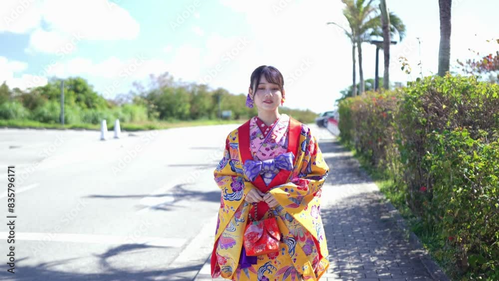 A young woman in her twenties, wearing traditional Ryusou, is walking ...