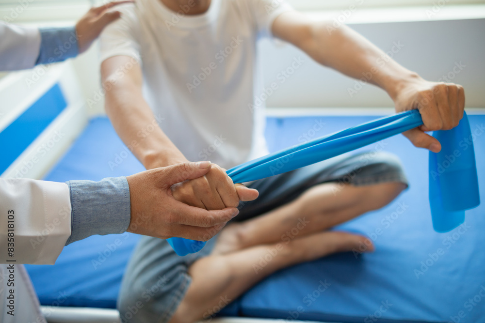 female doctor using elastic bands help patient regain muscle movement ...
