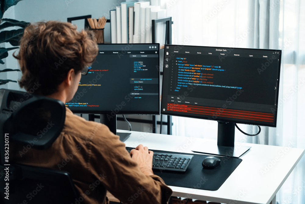 IT developer working online software development on pc monitors at ...