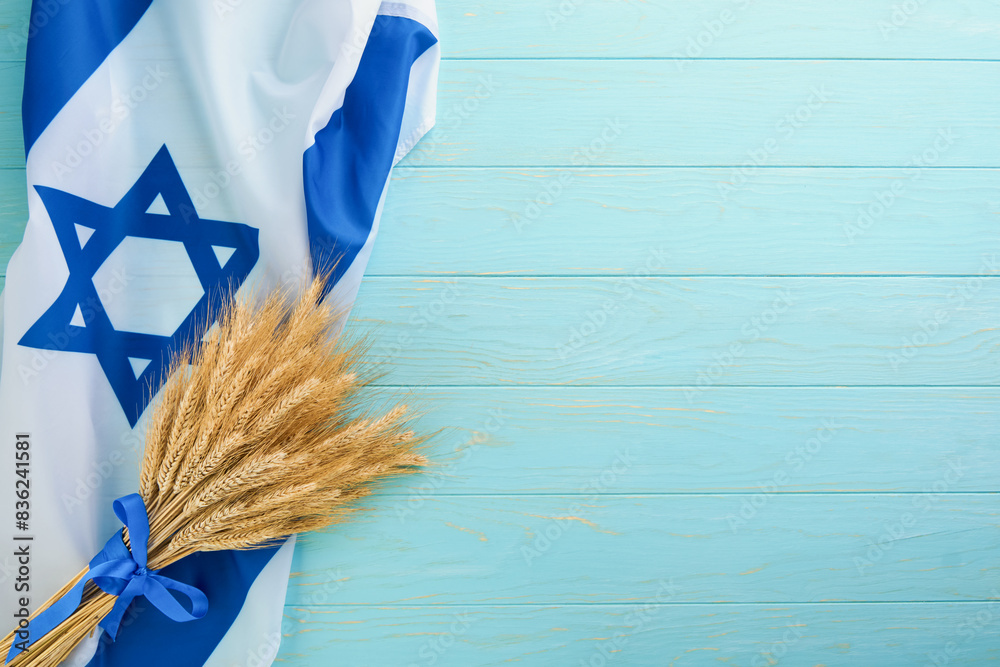 Shavuot jewish background. Ripe bouquet of wheat with blue ribbon with ...