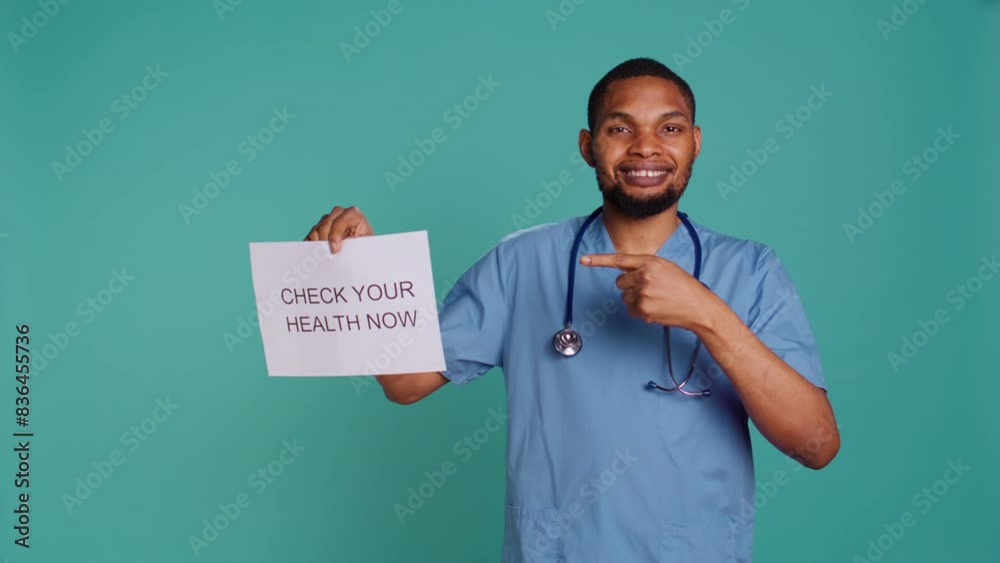 Video Stock Portrait of male nurse holding sign urging people to do ...