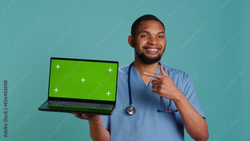 Portrait of practitioner showing medical instructions video on green ...