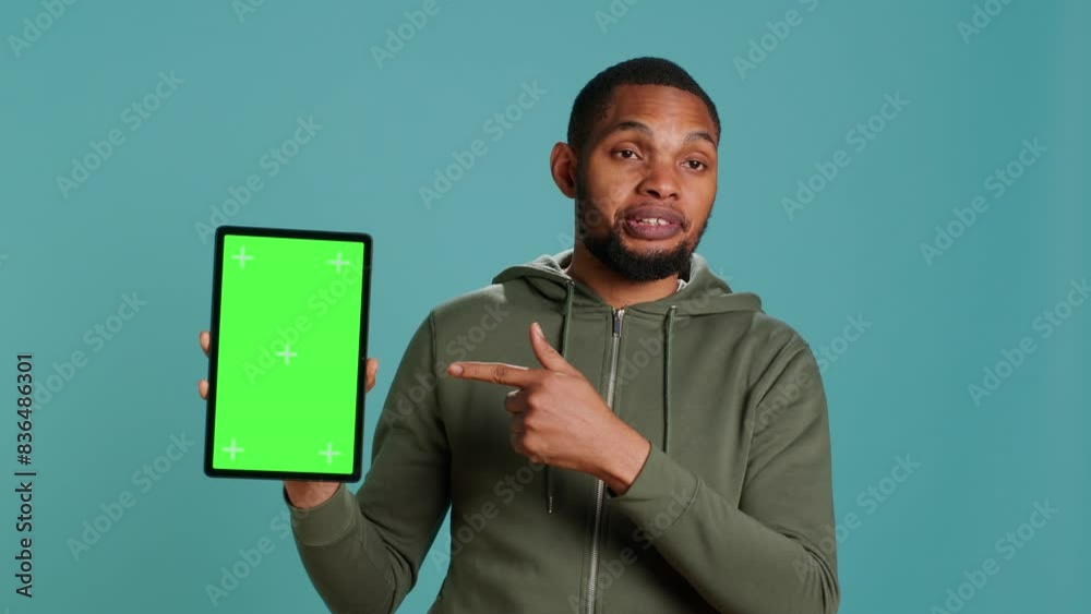 Joyous african american man holding isolated screen laptop, doing ...