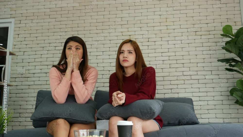 Two woman watch TV Series drama sadness crying on sofa couch home ...