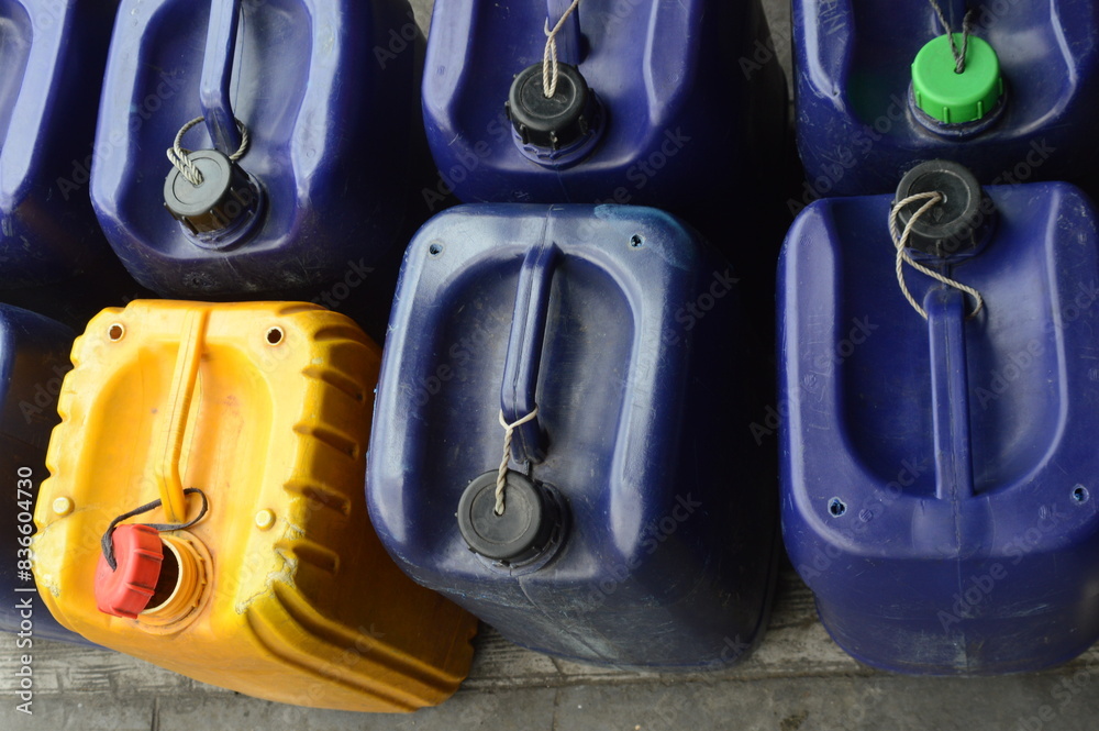 Collection of blue and yellow jerry cans Stock Photo | Adobe Stock