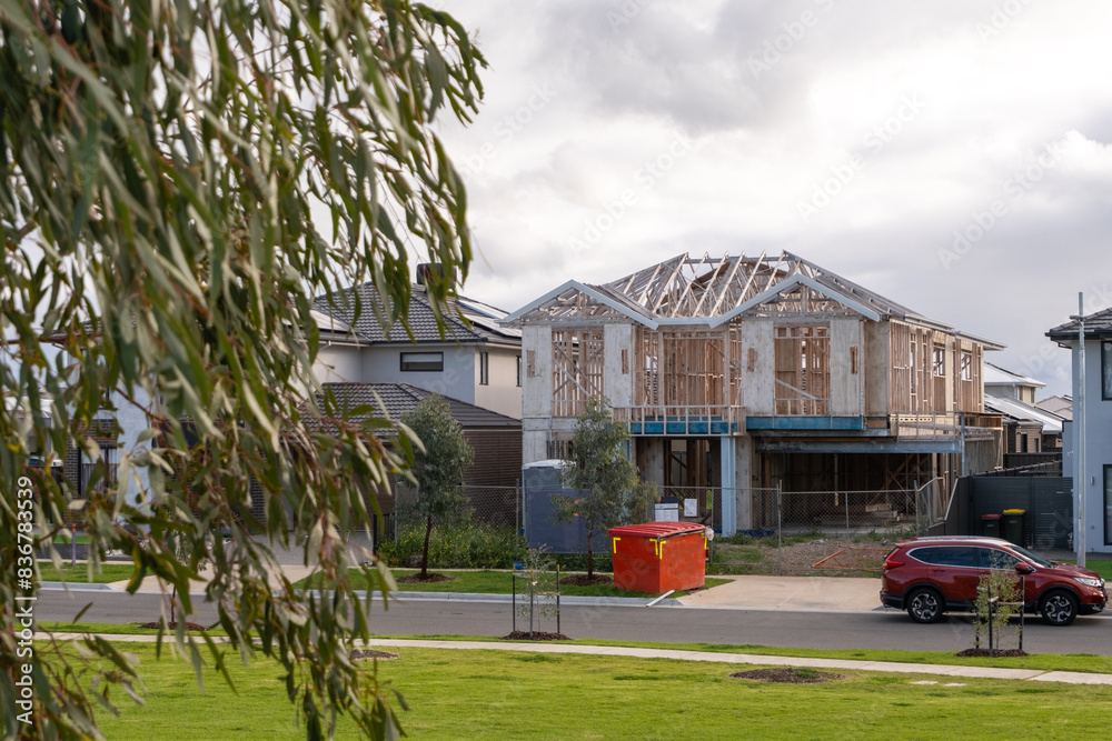 A construction site of an incomplete two-story house with timber ...