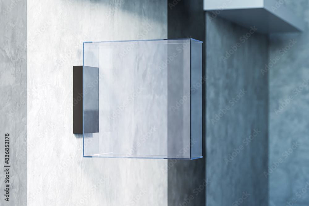 Blank glass signboard hanging on a textured wall, ready for branding or ...