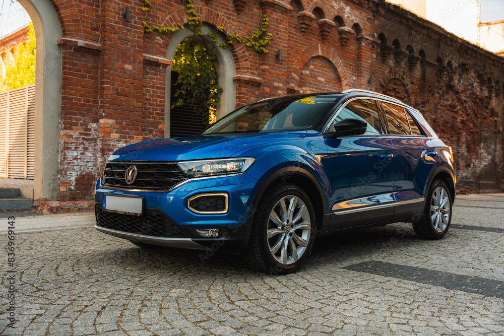 Photo of a blue Volkswagen T-Roc. They show details of the car. Rims ...