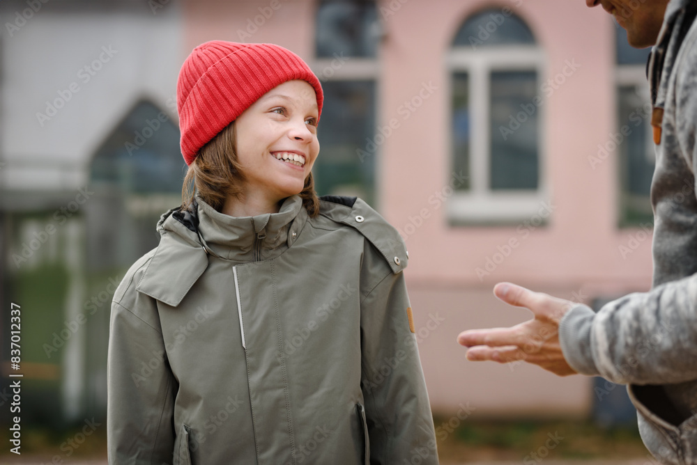 Cheerful smiling young boy talking with school teacher outdoor, Joyful ...
