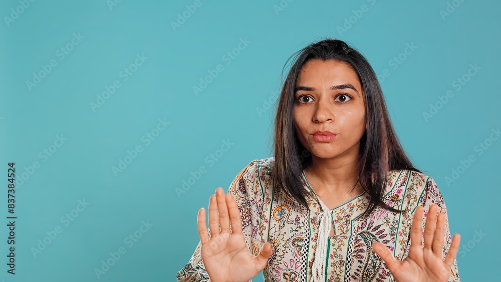 Stern indian woman doing stop hand gesture sign, complaining ...