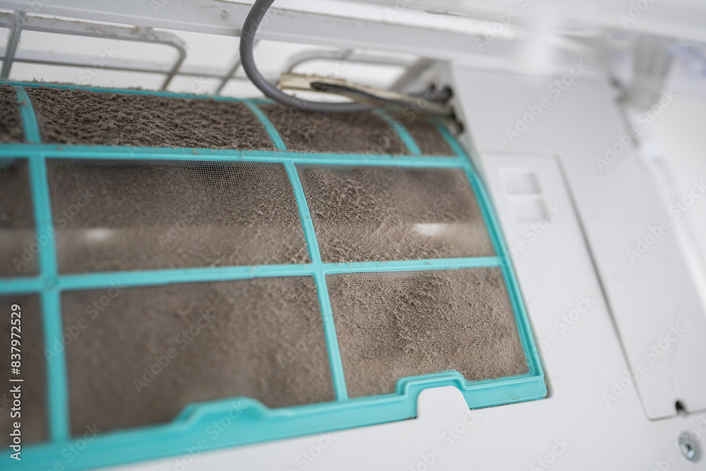 Closeup of dirty dust air conditioner filter on wall. Home air ...