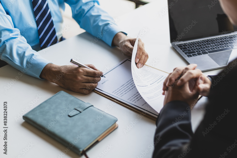 Job interviews, Employer in suit reading resume of job interview ...