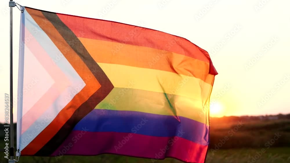 LGBT Pride Month. New LGBT flag waving against the wind, beautiful ...