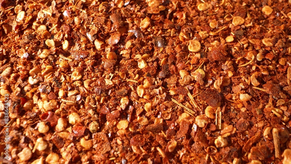 Zoom in on fiery ground chili, its coarse texture laden with seeds and ...
