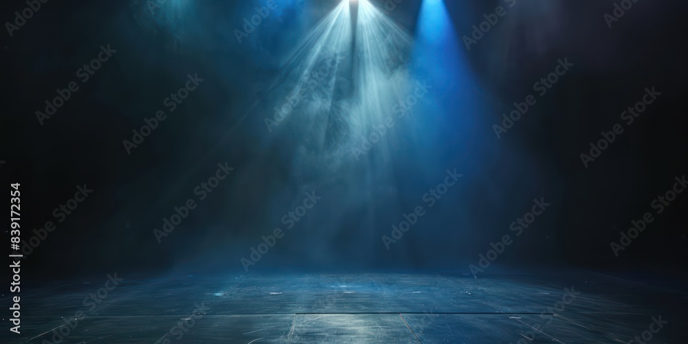 Dark, empty stage illuminated by a single spotlight, creating a dramatic and captivating ...