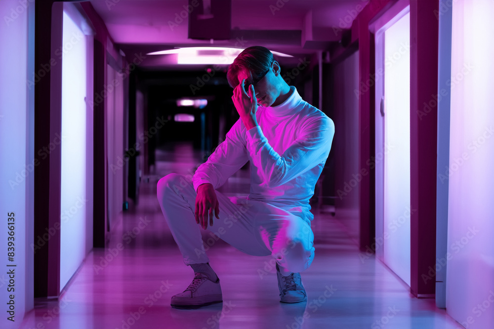 Envisioning Tomorrow: A Futuristic Man in White Clothes Sits on Floor ...