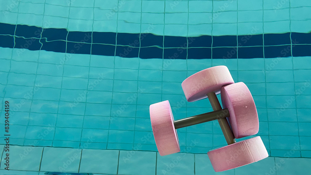 an empty swimming pool with Styrofoam exercise equipment floating in it ...