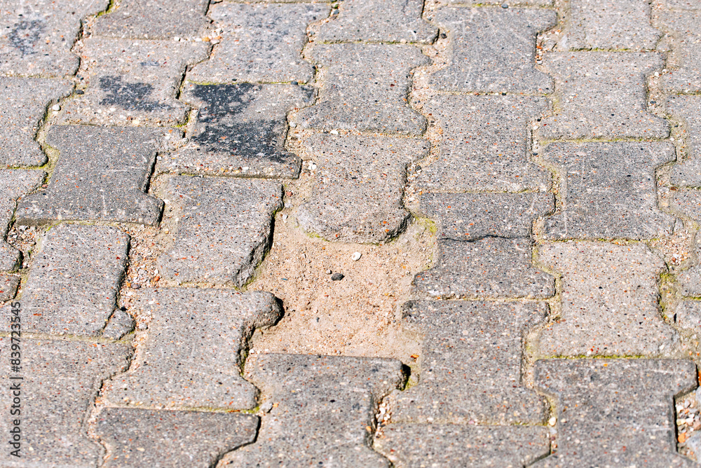 Defects on paving slabs, improperly laid paving stones. Sidewalk with ...