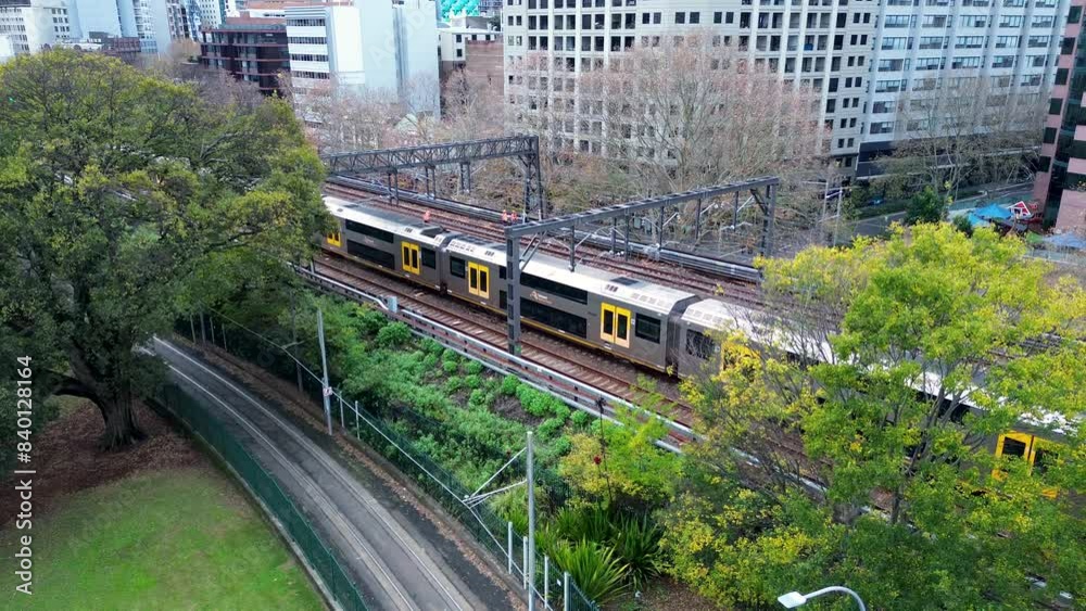 Landscape view of commuter train moving along railway tracks with ...