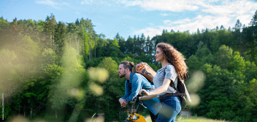 Travellers couple going on e-bike ride in nature. Tourist riding ...