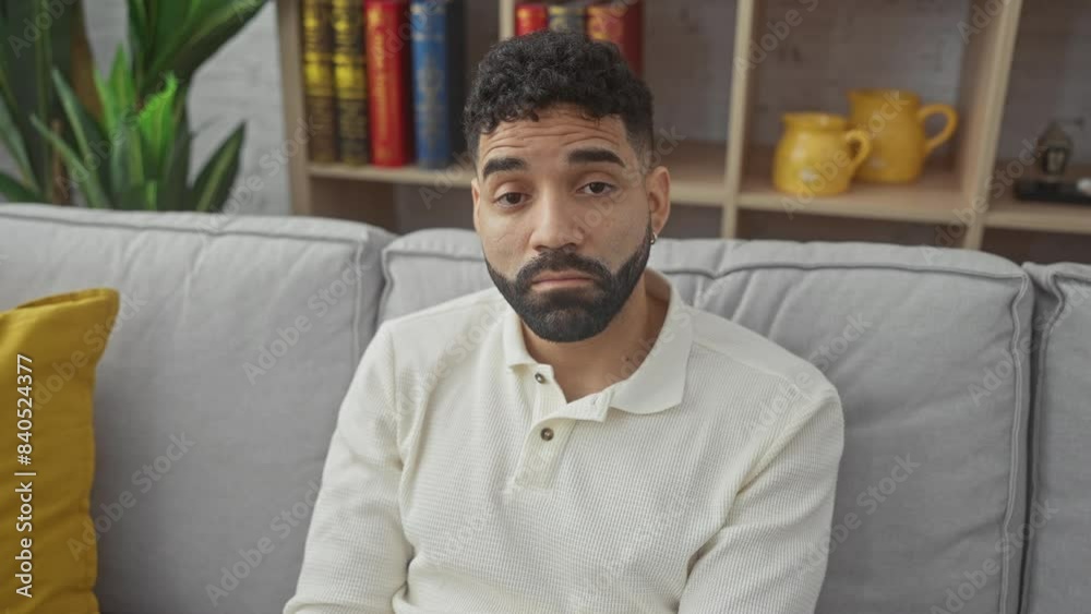 Exhausted young hispanic man waking up at home, looking sleepy and ...