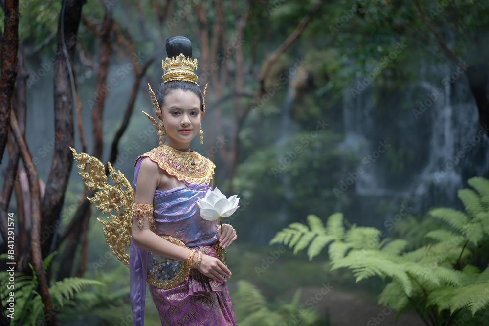 Beautiful girl in a Kinnari dress in green natural with the moss and ...