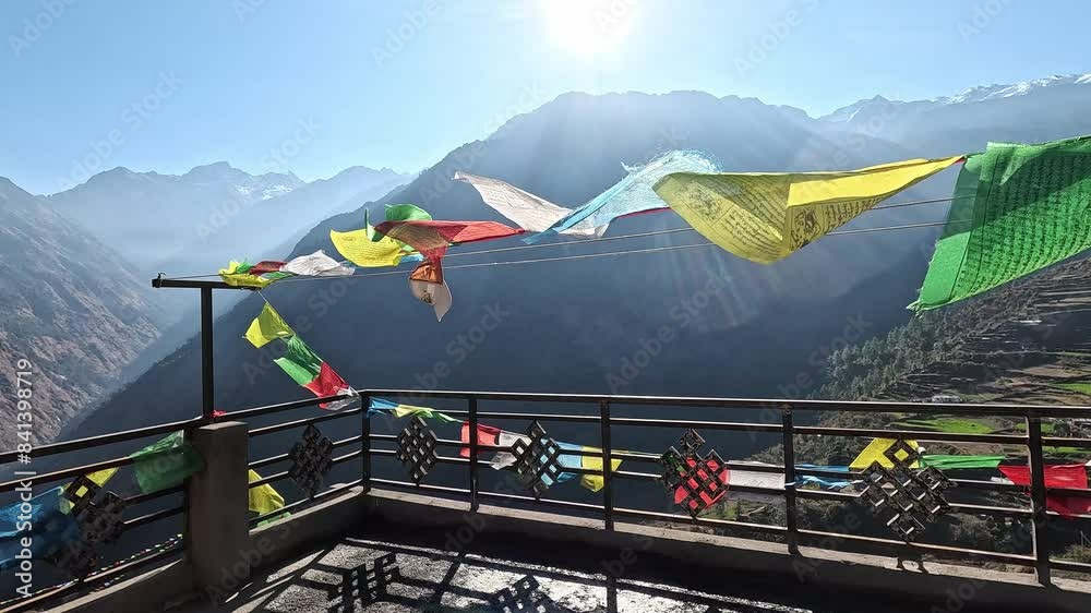 village rooftops with beautiful Buddhist Prayer Flags in the wind. Blue ...