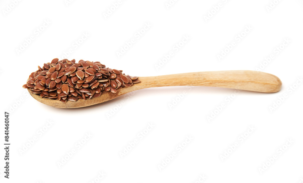 Side view of Brown flax seed on wooden spoon isolated on white ...