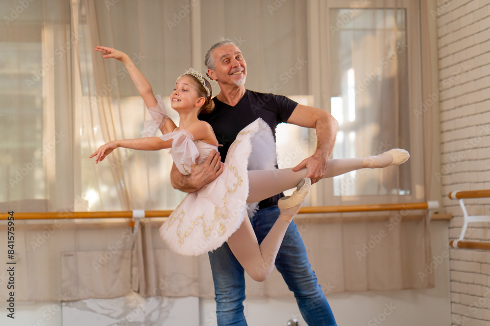 professional ballet school for children male teacher helps a girl ...