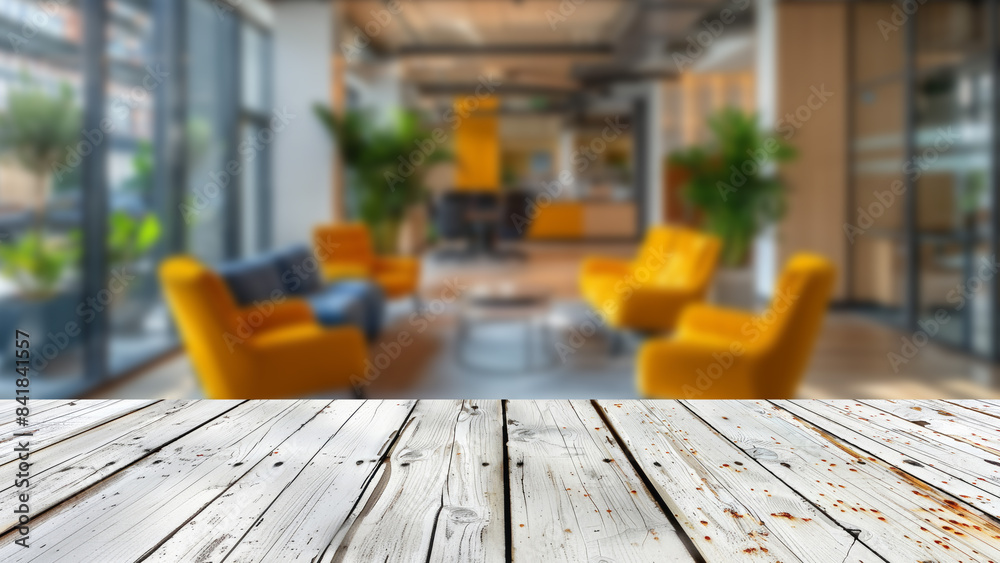 Foreground wooden office table with a blurry background of a ...