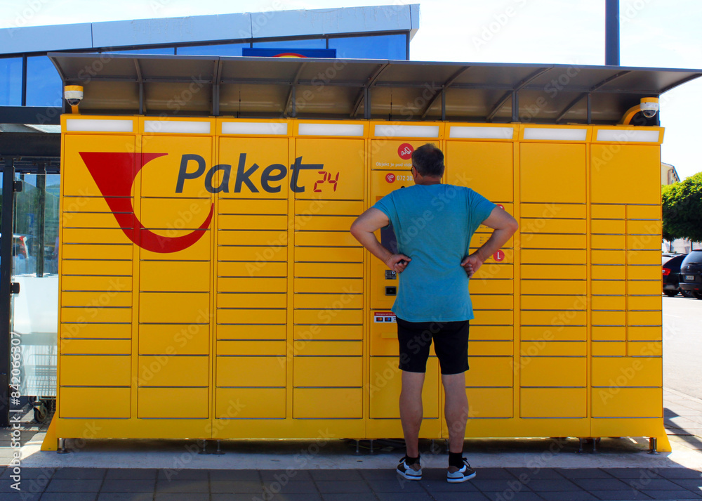 KRK, Croatia, Paket24 post terminal, 06.06.2024, Man picking up a ...