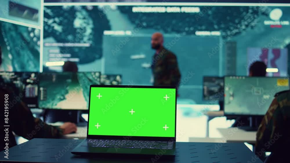 Greenscreen running on a laptop in military base command center, team ...