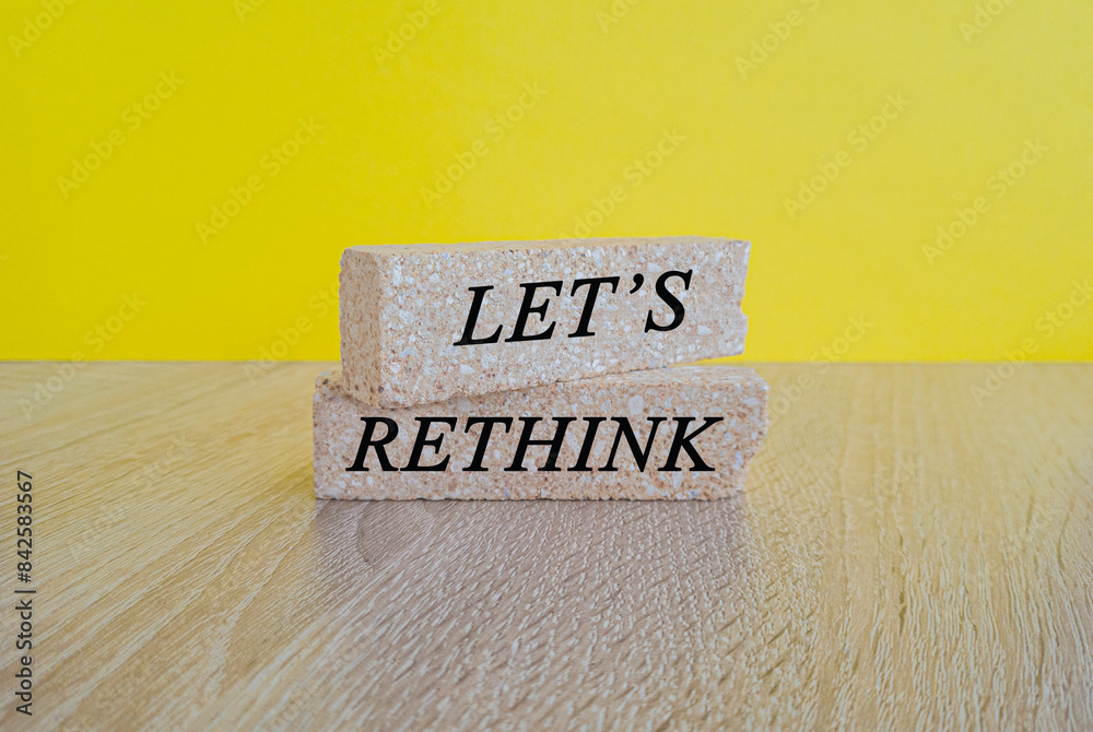 LET'S RETHINK symbol. Concept words LET'S RETHINK on brick blocks ...